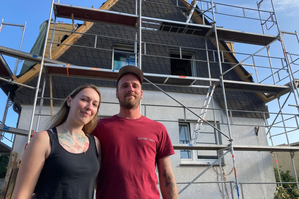 Junges Paar kommt mit Gedicht zu Eigenheim